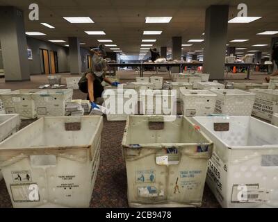 Election workers count ballots as they close a polling station at the ...