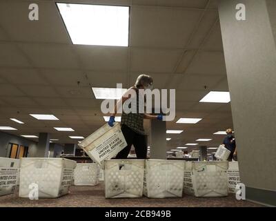 Election workers count ballots as they close a polling station at the ...