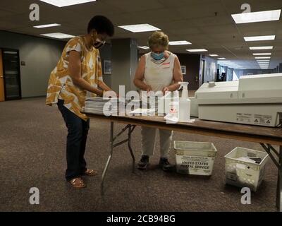 Election workers count ballots as they close a polling station at the ...