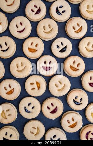 Homemade Jammie Dodgers. Smiling face biscuits faces on a wire rack ...