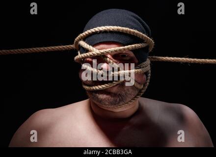 Picture of binded scary man with rope on face Stock Photo - Alamy