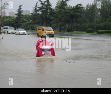 Chengdu, China. 11th Aug, 2020. The street was flooded by a heavy rain ...