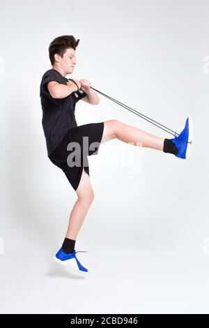 Young man trains by jumping rope in the gym Stock Photo - Alamy