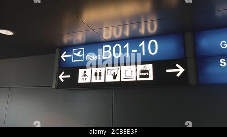 Blue terminal location indicators signs at the airport Stock Photo - Alamy