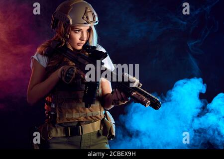 Female storm trooper in military camouflage uniform protected with ...