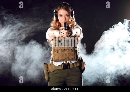 Woman pointing a gun and wearing a black corset and tutu Stock Photo ...