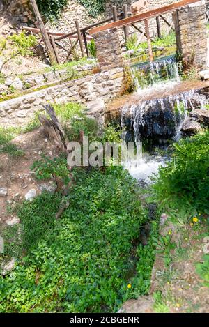 Piccolo makes water and forms a small waterfall on a sunny day Stock ...