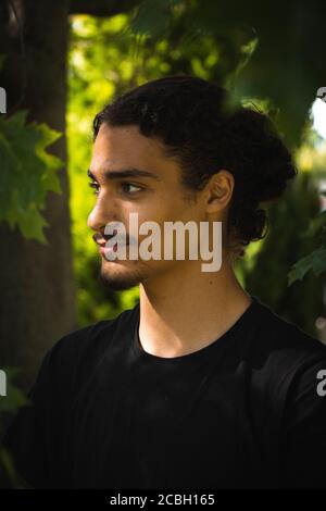 Vertical shot of a Hispanic male wearing a surgical mask. The Christmas ...