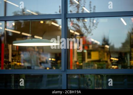 supermarket store windows with lights and advertisements inside Stock ...