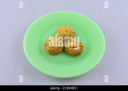 Green beads on plate on green background Stock Photo - Alamy