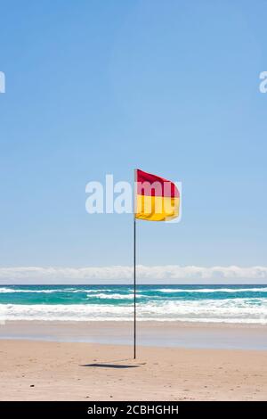Australian lifeguard signs and red and yellow flags at Four Mile Beach ...