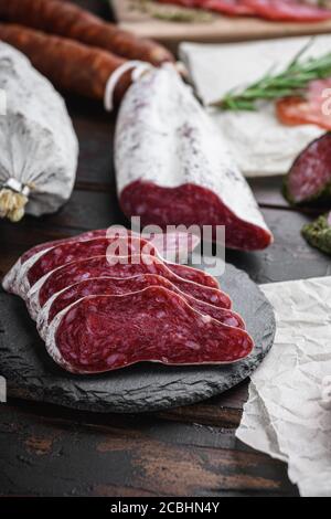 Variety of dry cured chorizo, fuet and other sausages cut in slices ...