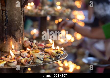 devotees lighting lemon lamps as a hindu ritual Stock Photo - Alamy