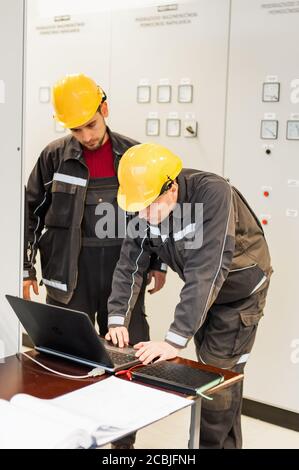 Field service crew engineers inspect relay protection system with ...