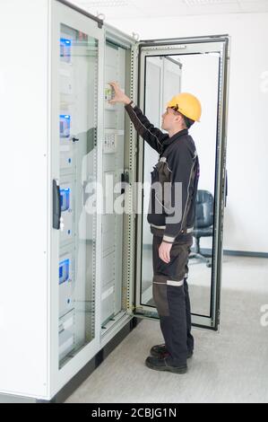 Maintenance engineer testing medium voltage switchgear and bay control ...