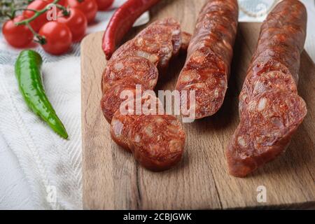 Traditional chorizo cuts with spices and ingredients on white surface ...