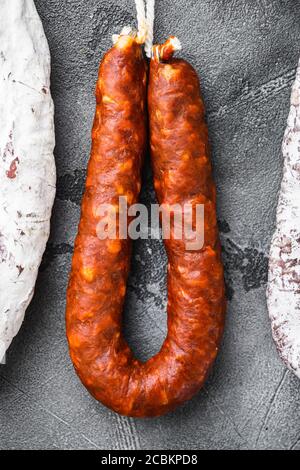 Spanish dry salami from a rack at market on grey background, topview ...