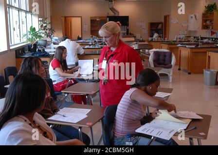 An American science classroom with desks in rows and lab tables in the ...