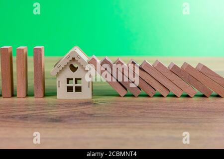 Economy and business concept. There is a wooden house and a sign on the ...