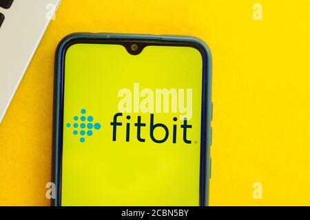 In this photo illustration a Fitbit logo seen displayed on a smartphone ...