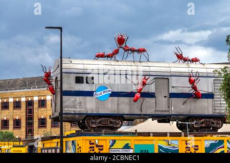 Red ant sculptures crawling over a train carriage at a restaurant in ...