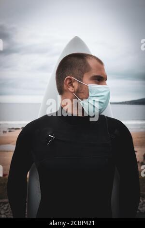 Surfboard Surfer, Man in Mask and Wetsuit on the Beach Stock Photo - Alamy