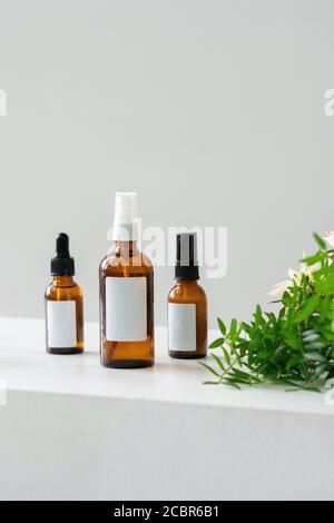 Light cosmetic background. Vials, glass laboratory flasks on the table ...