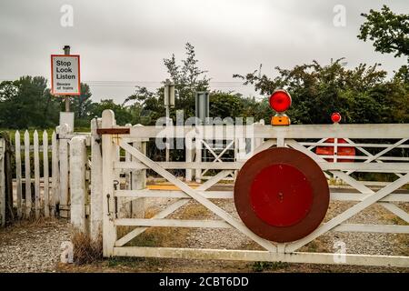 White gate on a pedestrian rail crossing on a UK rail line Stock Photo ...
