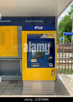 A yellow self-service ticket machine box on board a De Lijn electric ...