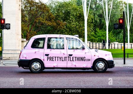 London taxi female taxi driver driving appropriate pink lady cab ...