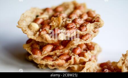 Peanut Peyek on white background. Peanut Rempeyek or Peyek is a deep ...