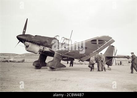 "The pilot of a Junkers Ju 87 ""Stuka"" is ""dressed"" before take-off ...