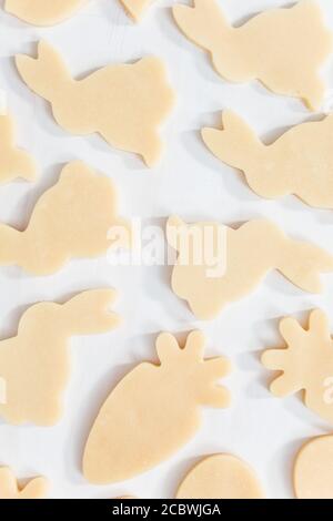 Flat lay. Unbaked Easter sugar cookies on a white table Stock Photo - Alamy