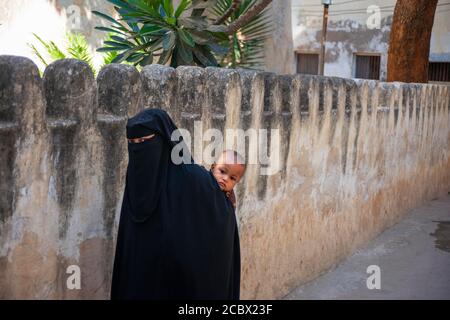 Old Swahili woman of Lamu Island wearing the black buibui head cloth ...