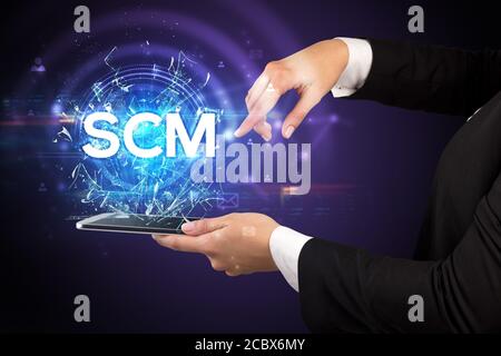 Close-up of a touchscreen with SCM abbreviation, modern technology ...