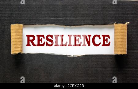 The text 'resilience' appearing behind torn black paper. Beautiful ...