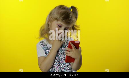 happy child with smartphone on yellow background. ok Stock Photo - Alamy