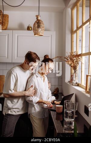 Husband and wife working from home on laptop Stock Photo - Alamy