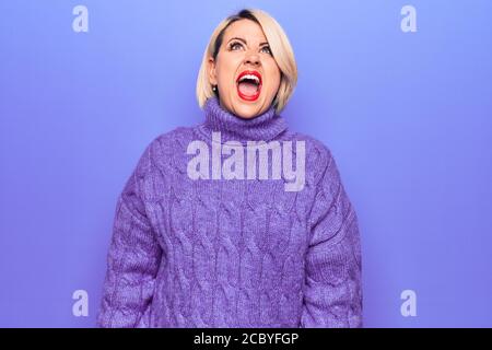 Plus size woman wit purple hair standing over isolated background with ...