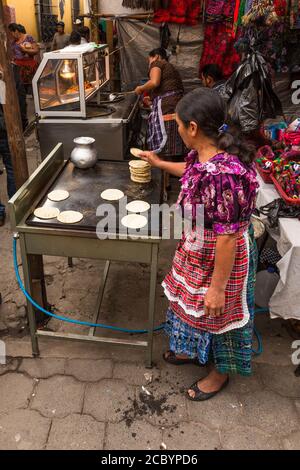 Mayan woman cooking tortillas on traditional oven Guatemala Stock Photo ...