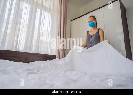 Young Female Housekeeper wearing a medical mask due to coronavirus ...