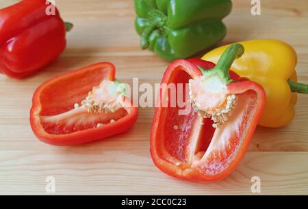tricolor pepper on a wooden background Stock Photo - Alamy