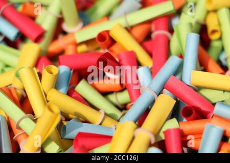Closeup shot of a heap of colorful tombola tickets on the white ...