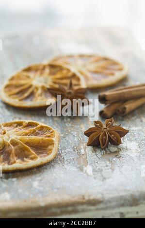 Dried orange slices, cinnamon and star anise on wooden table with copy ...