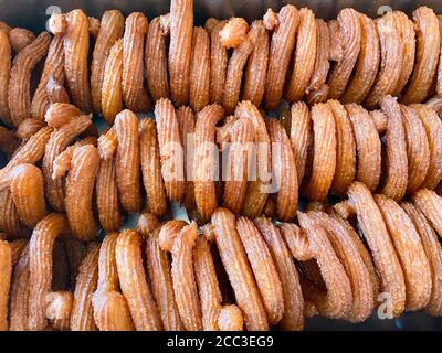 Turkish Dessert Churros Halka Tatli frying in hot oil. Turkish ...