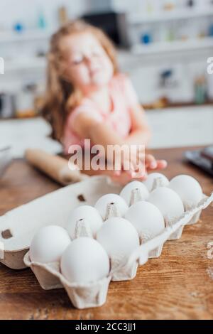 Person taking chicken egg from box, wooden background Stock Photo - Alamy
