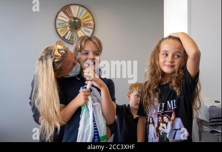 Reilly Stancombe gets a kiss from mum Daisy as brother Roman and sister ...