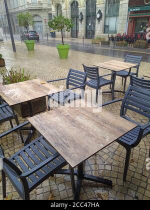 Rain drops on wooden tables in a street cafe Stock Photo - Alamy