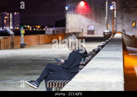 Woman looking at mobile phone at night Stock Photo - Alamy