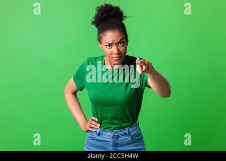 Unhappy girl pointing finger to camera in disagreement Stock Photo - Alamy